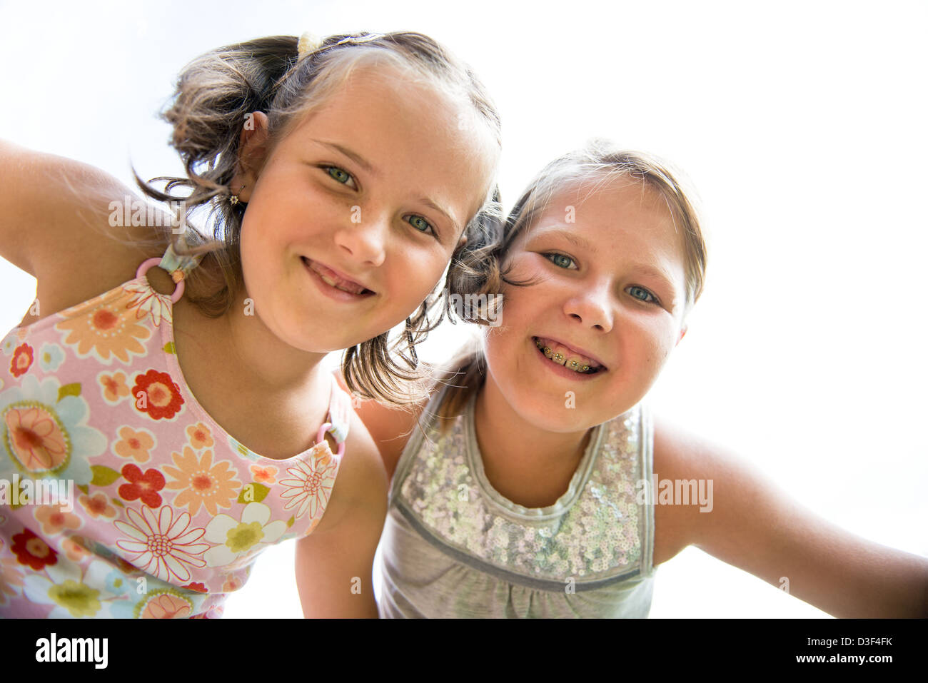 Portrait of two small happy smiling children from bellow Stock Photo ...