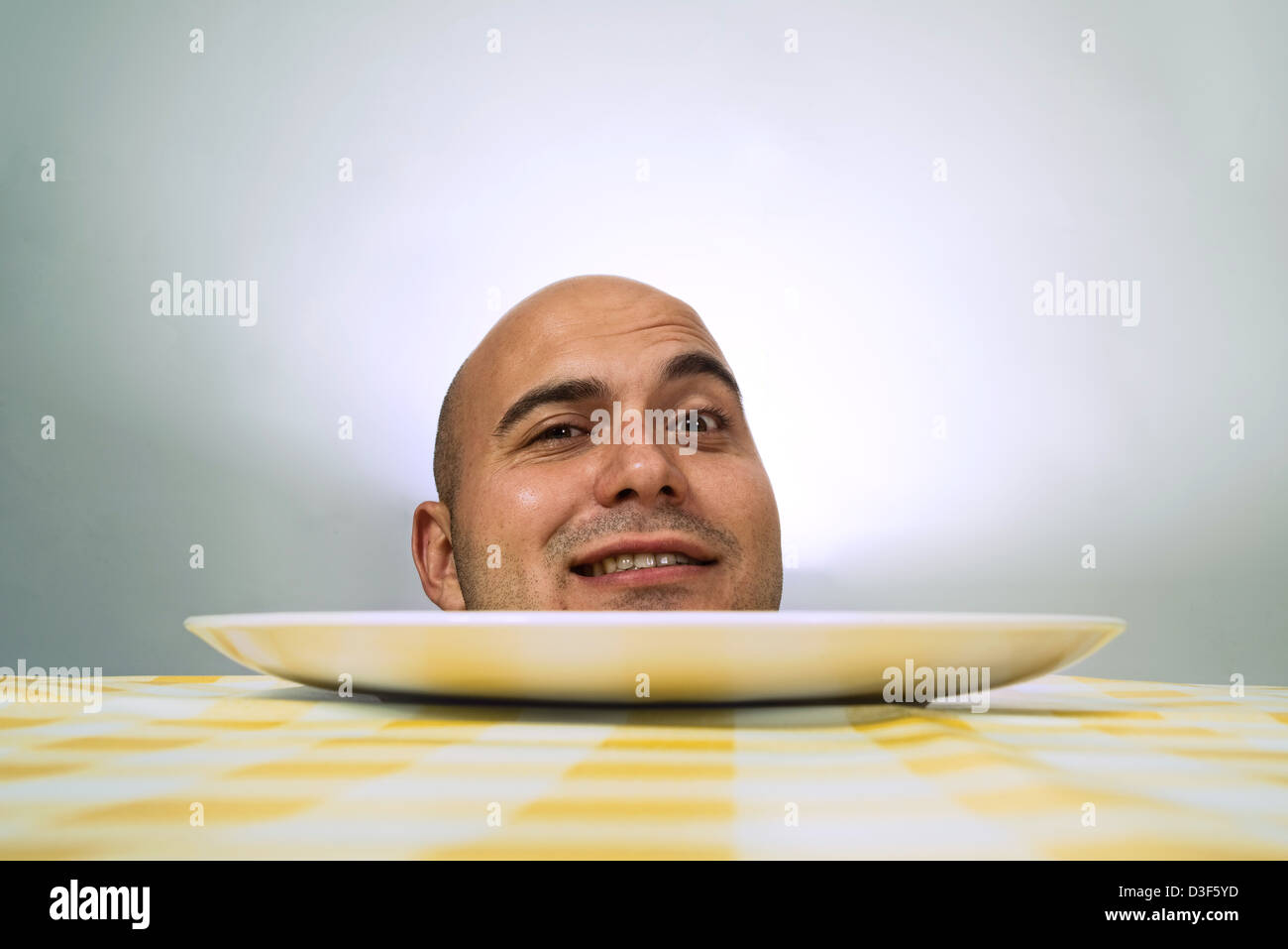 Bold human head with open eyes on a dinner plate Stock Photo - Alamy