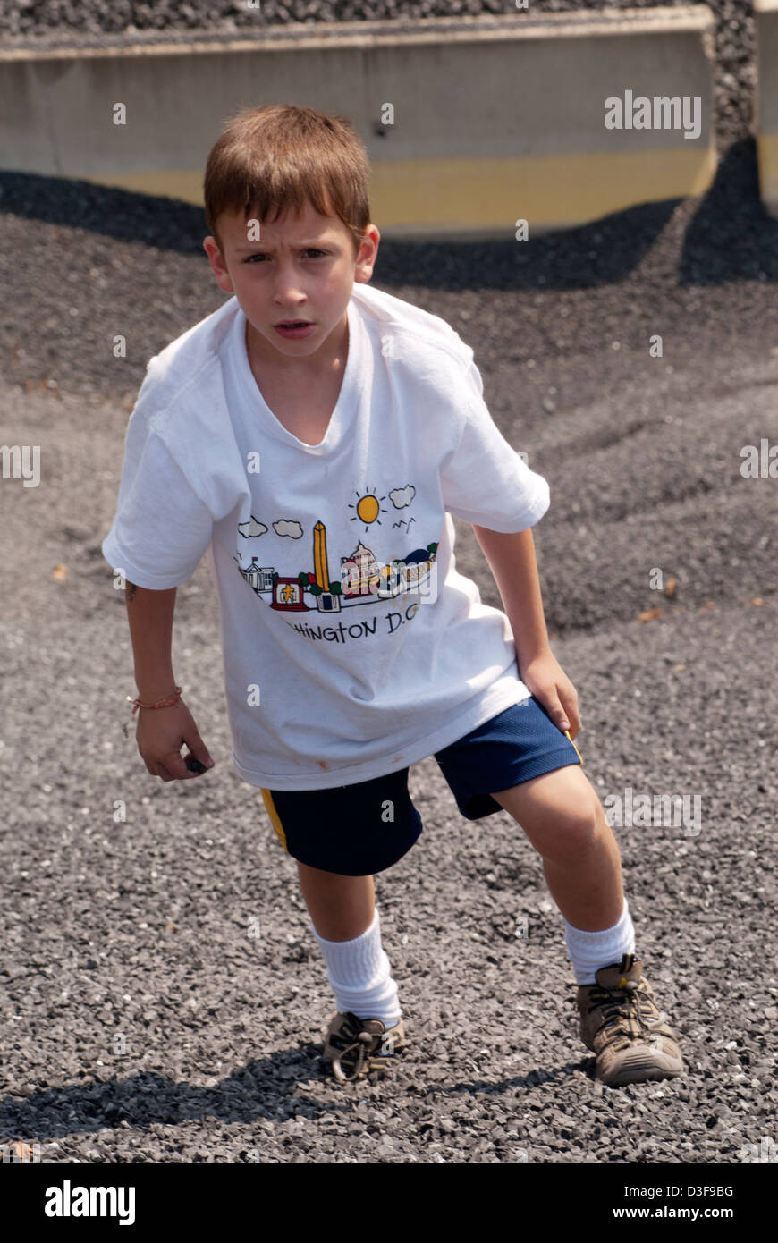 autistic boy at play on a large gravel slope Stock Photo - Alamy