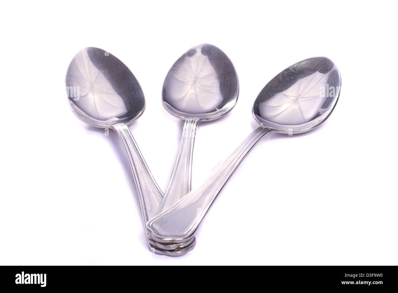 Close up view detail of some spoons isolated on a white background ...