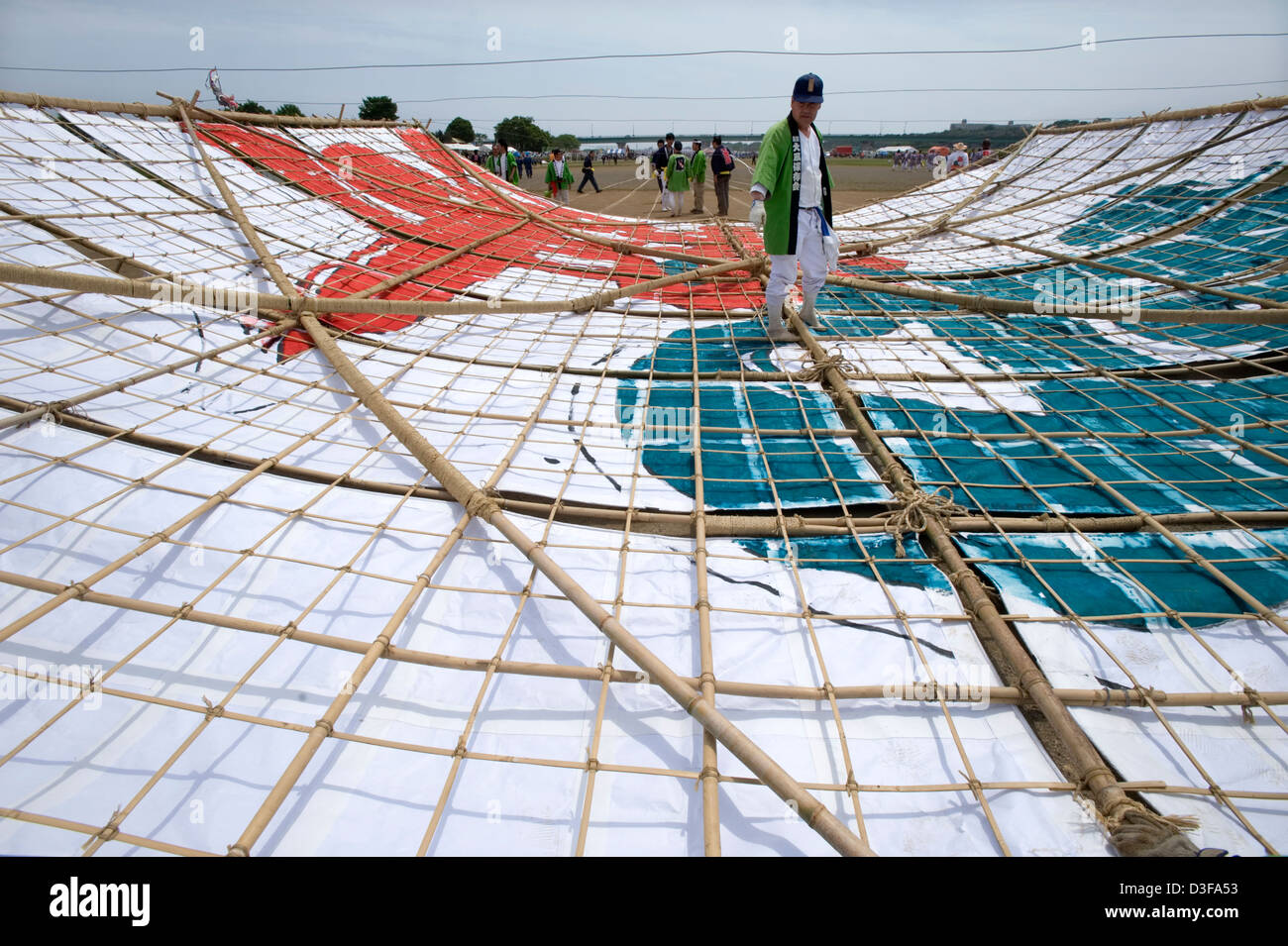 Man inspecting giant paper & bamboo kite weighing 950 kilos measuring ...