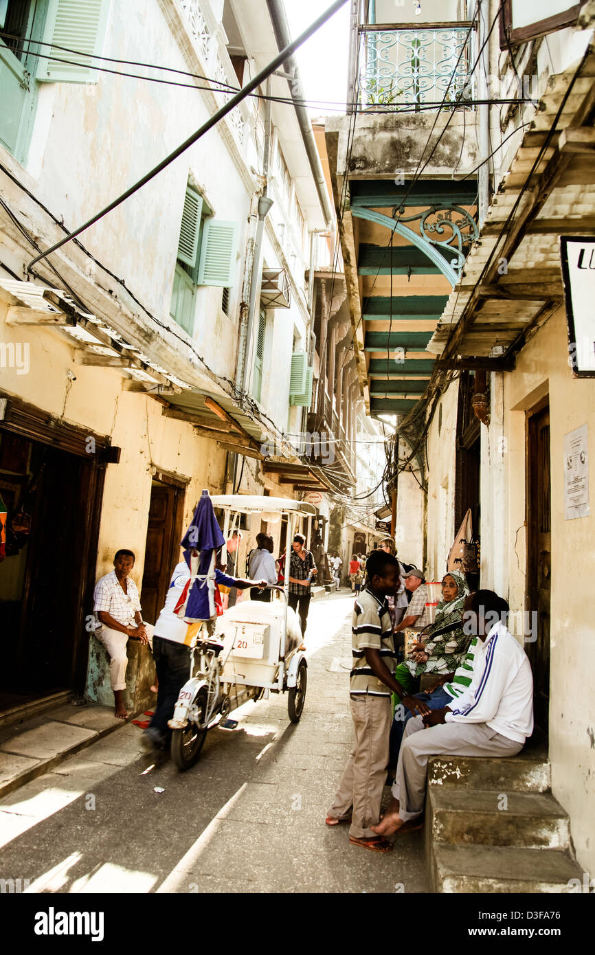 Locals and Tourists haggle in the alley shops of Stonetown, Zanzibar ...