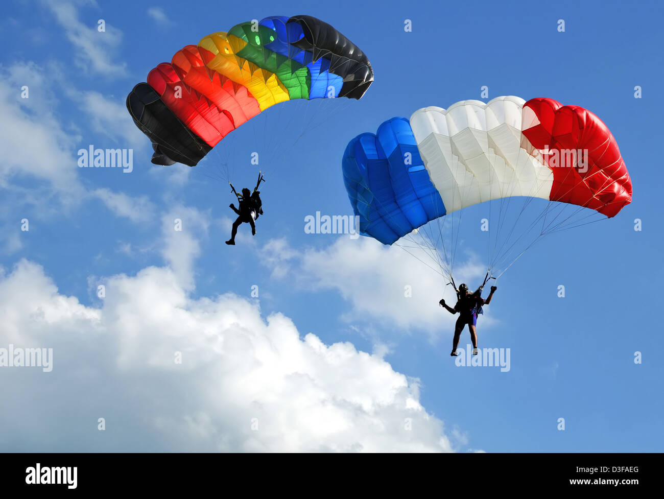 Two colorful parachutes on blue sky Stock Photo - Alamy