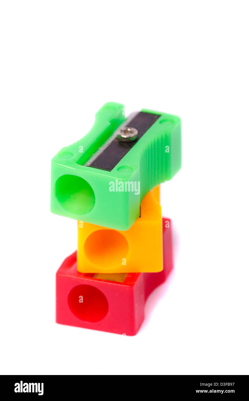 Close up view of three pencil sharpeners isolated on a white background ...