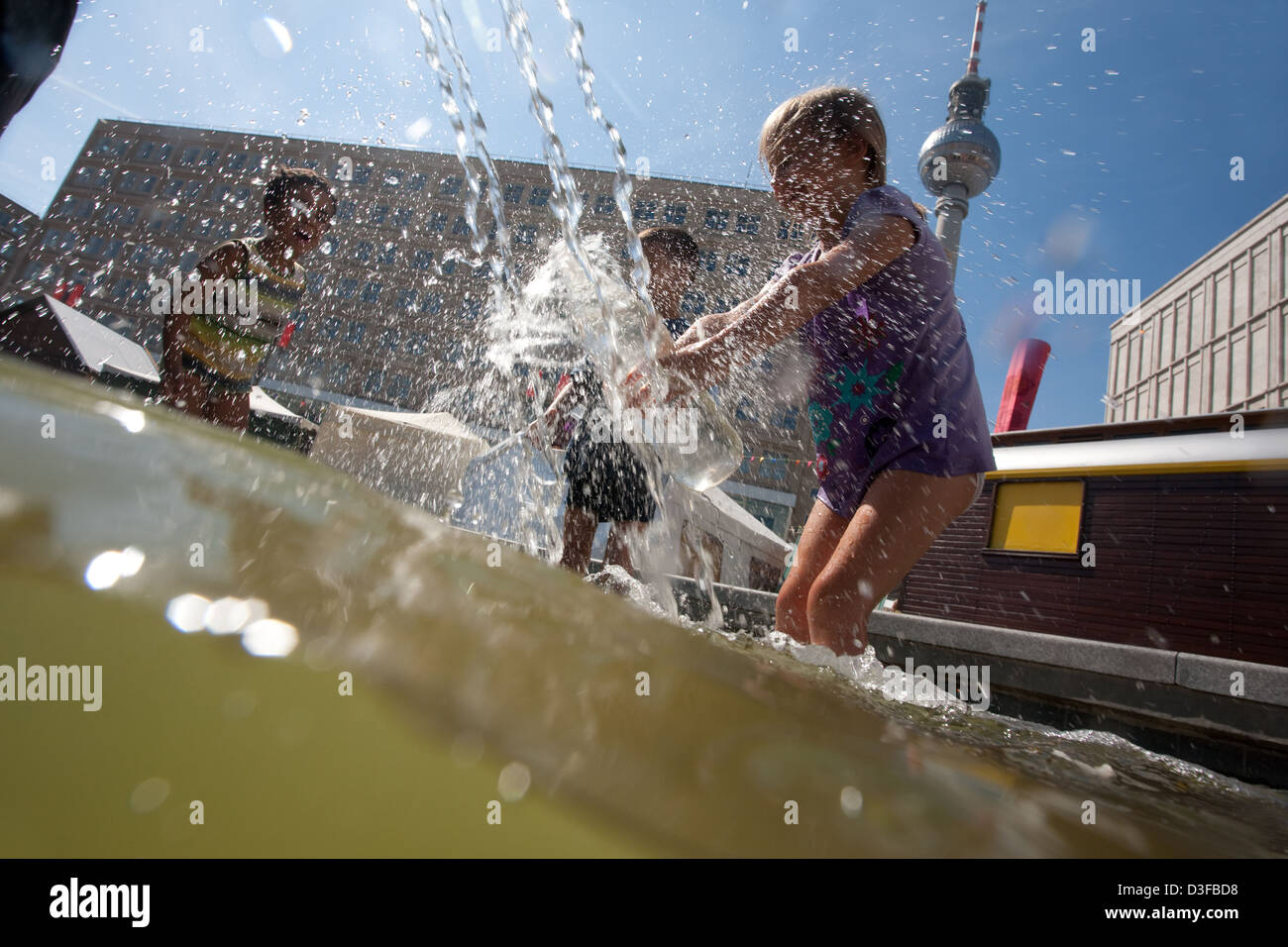 Berlin, Germany, children playing in the water of the fountain of ...