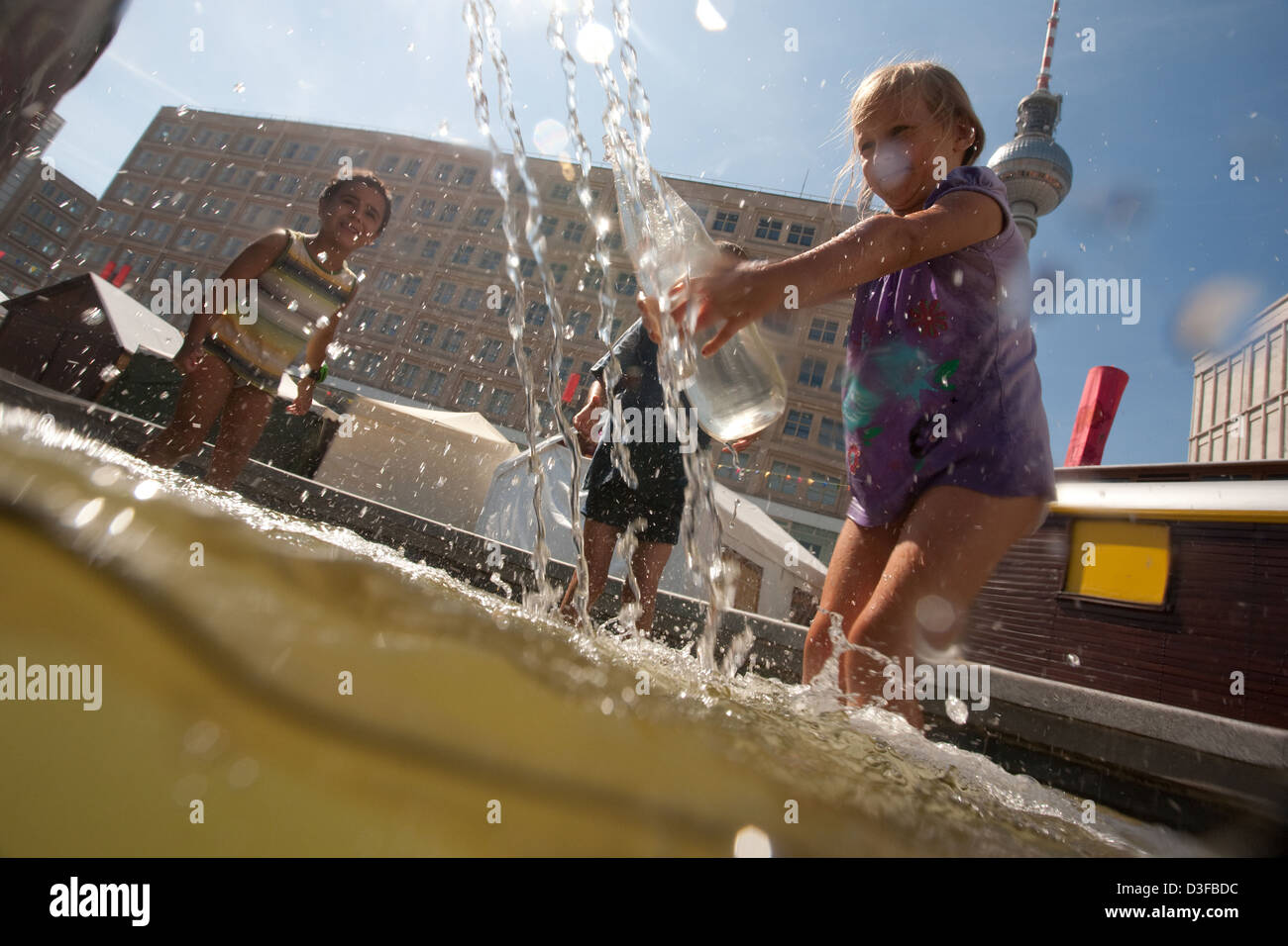 Berlin, Germany, children playing in the water of the fountain of ...
