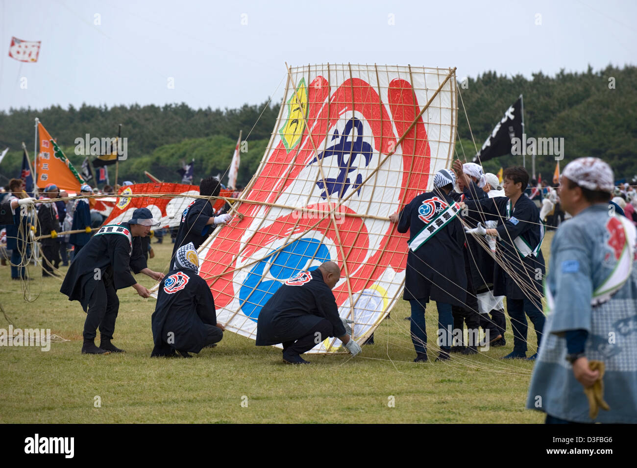Team members hold kite ready for launch at Hamamatsu Takoage Gassen ...