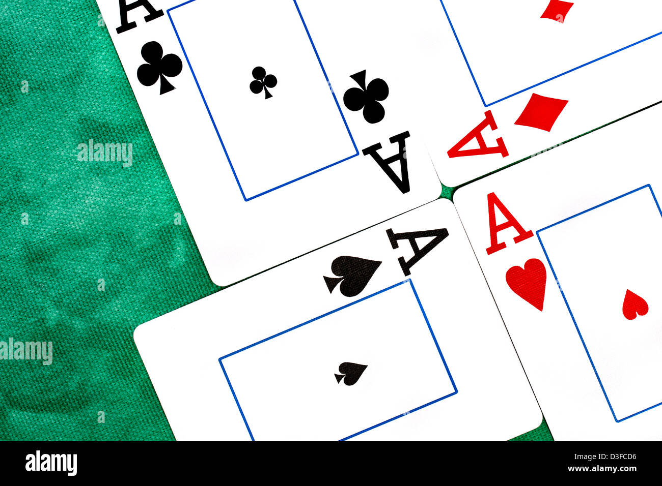 Close up view of a set of four aces spread on a green cloth table Stock ...