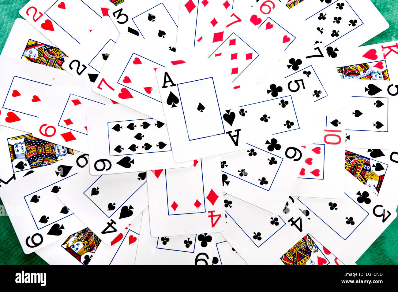 Close up view of a bunch cards spread on a green cloth table forming a ...
