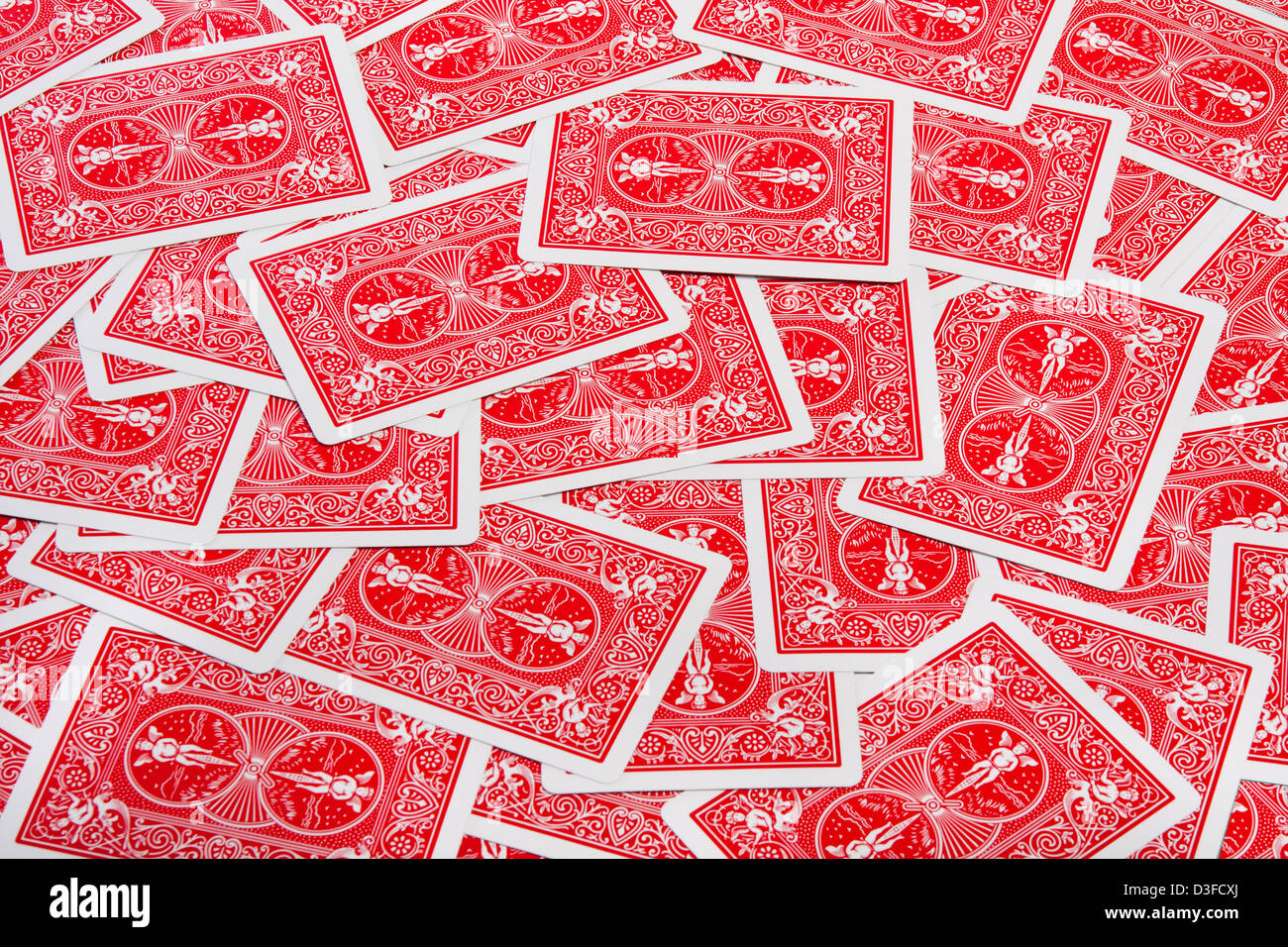 Close up view of a bunch of flipped playing cards spread on a green ...