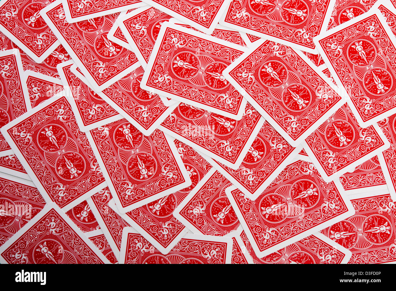 Close up view of a bunch of flipped playing cards spread on a green ...