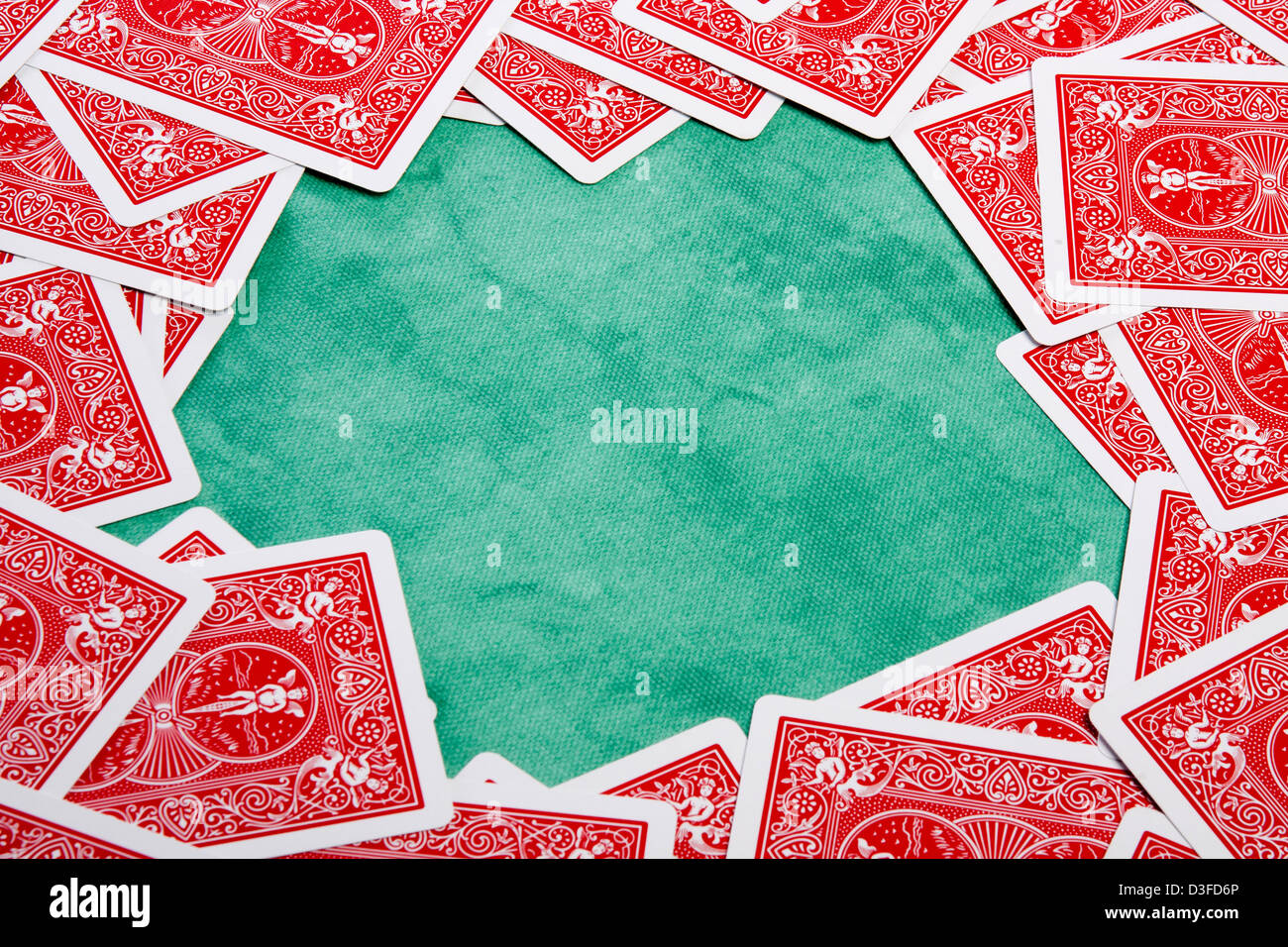 Close up view of a bunch of flipped playing cards spread on a green ...