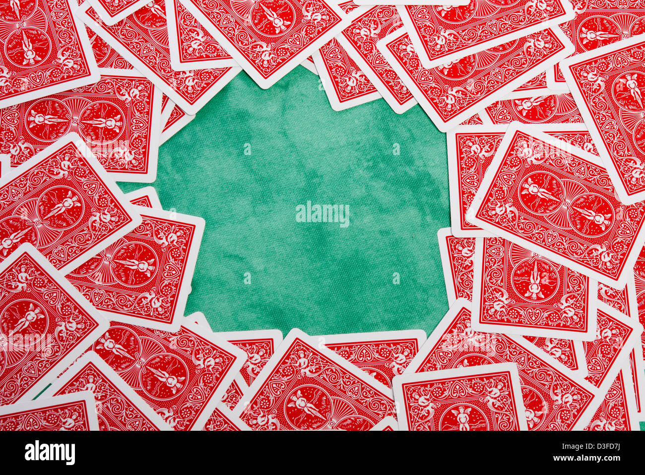 Close up view of a bunch of flipped playing cards spread on a green ...