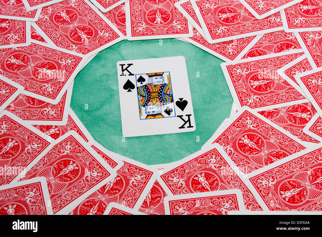 Close up view of a bunch of flipped playing cards spread on a green ...