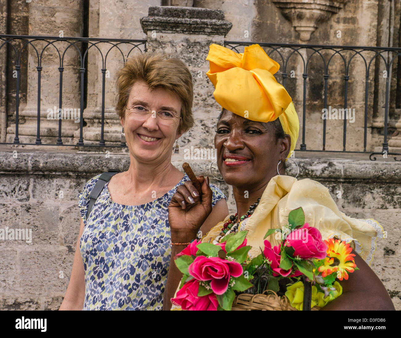 A Cuban cigar smoking dark skinned woman poses with a light skinned ...