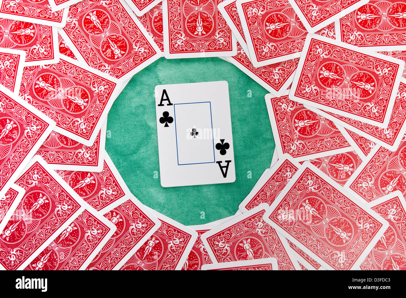 Close up view of a bunch of flipped playing cards spread on a green ...
