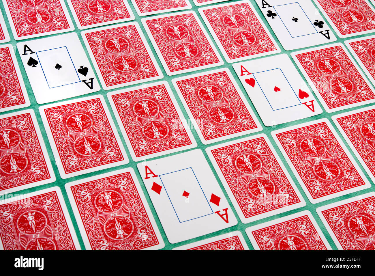 Close up view of a bunch of flipped playing cards spread on a green ...