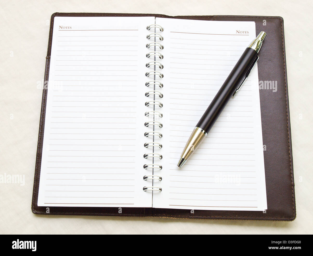 Opened pocket notebook and ballpen on the right Stock Photo - Alamy