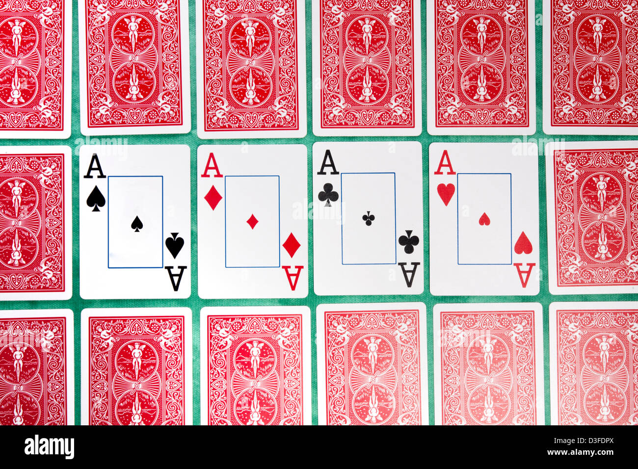 Close up view of a bunch of flipped playing cards spread on a green ...