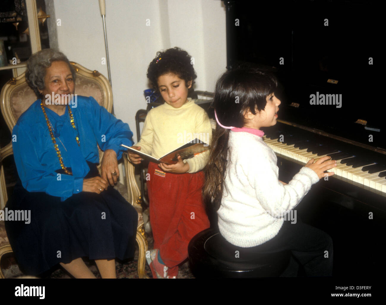 Coptic grandmother and children playing the piano, Cairo, Egypt Stock ...