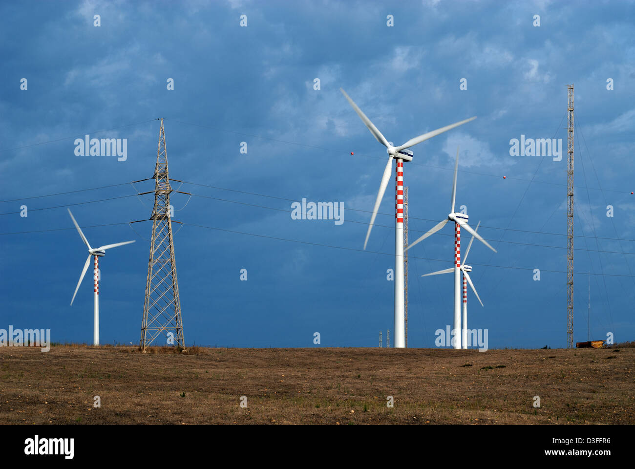 Porto Torres, Italy, electricity pylons and wind wheels of the power ...