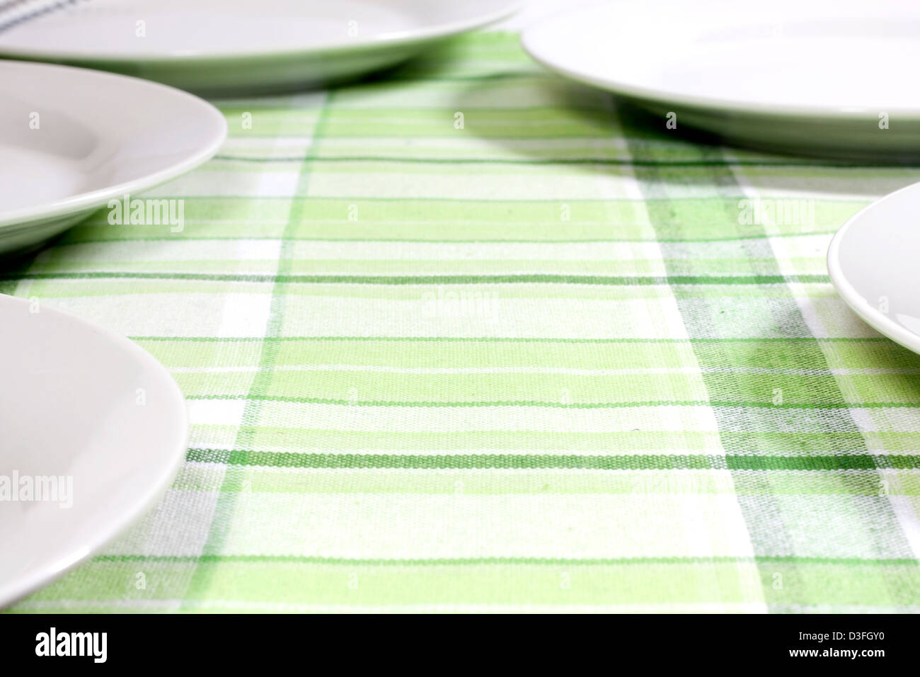 Plates on tablecloth in kitchen abstract food background Stock Photo ...