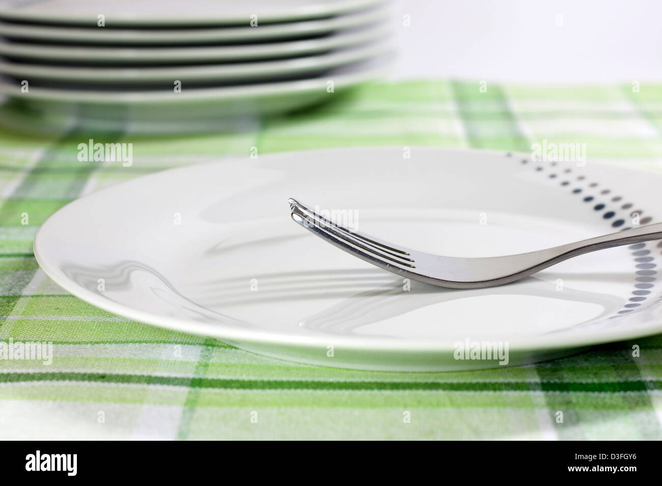 Plates on tablecloth in kitchen abstract food background Stock Photo ...