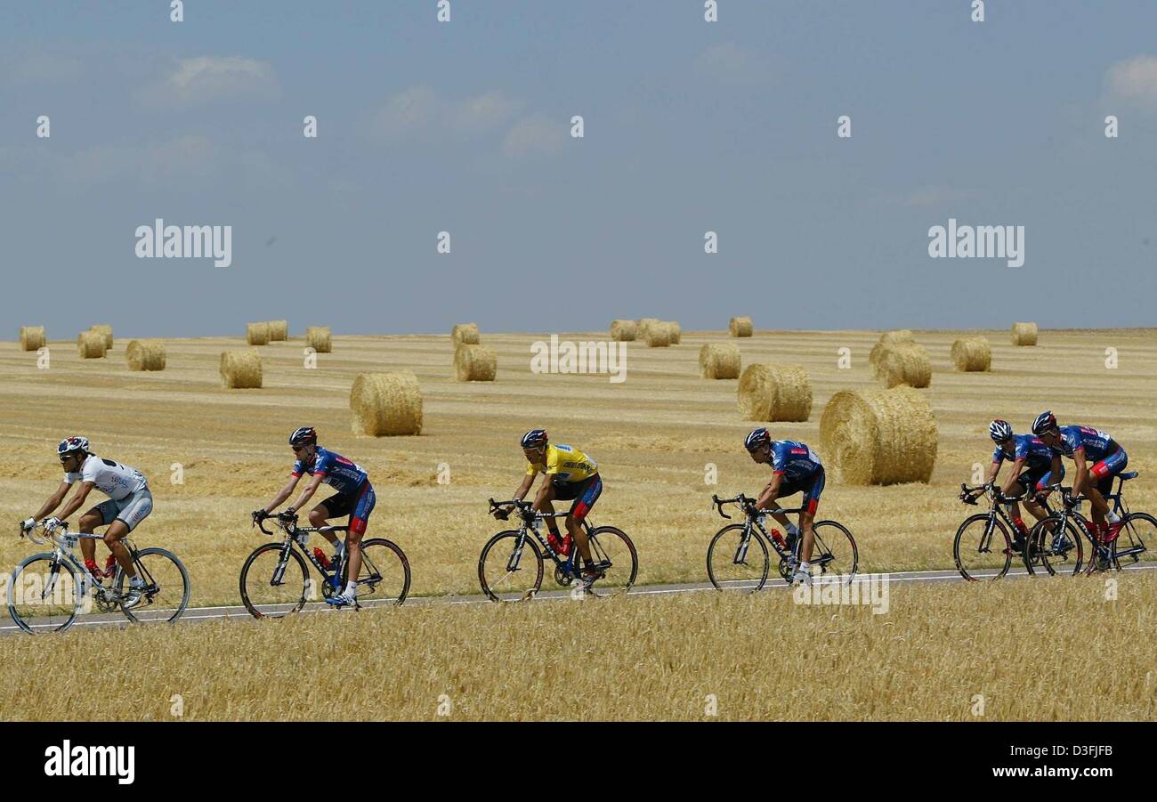 (dpa) - Cyclists pass by hay rolls during the fifth stage of the 2003 ...
