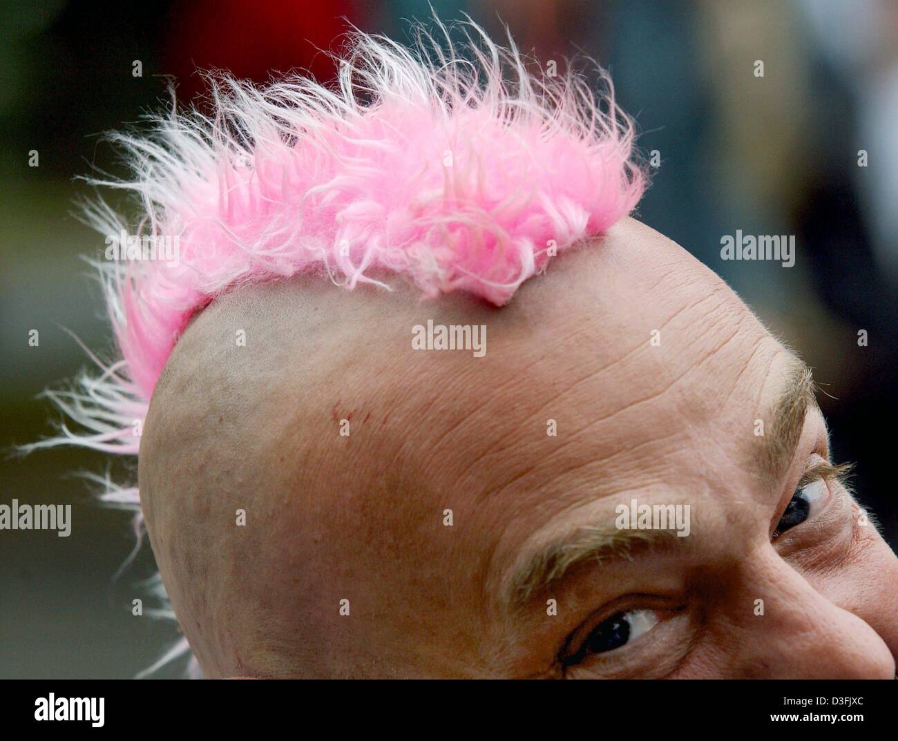 (dpa) - A man shows off his fluffy pink mohawk haircut during the ...