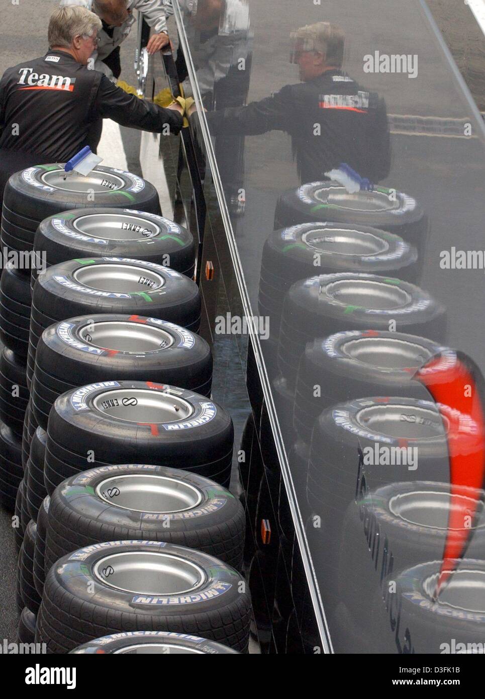 (dpa) - Tyres are stacked in front of a truck of the McLaren-Mercedes ...