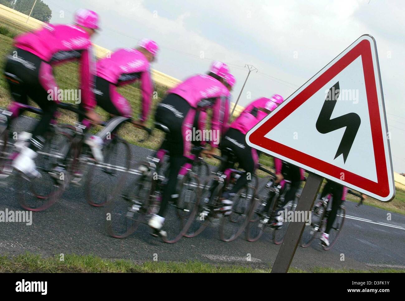 (dpa) - The cyclist of Team Telekom ride their bicycles along a road ...