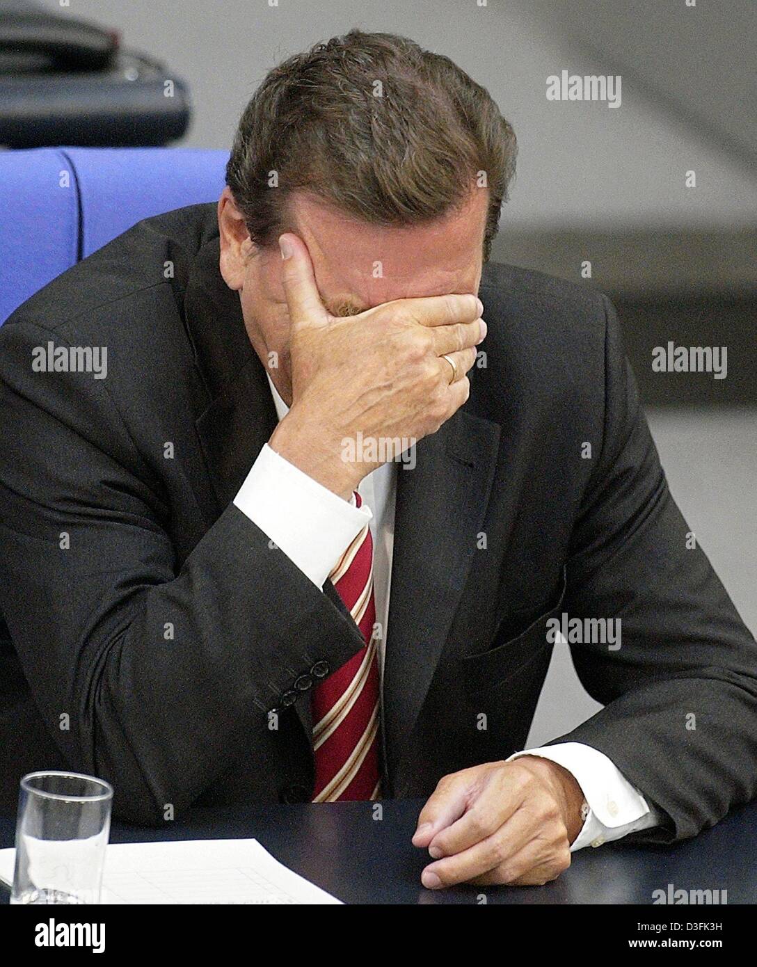 (dpa) - German Chancellor Gerhard Schroeder covers his face with his ...