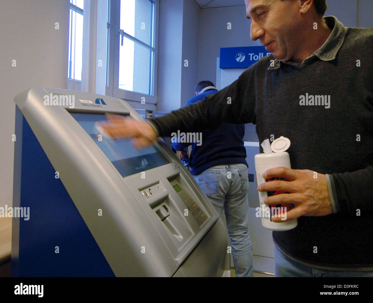 Employees of German highway toll company Toll Collect set up and clean ...
