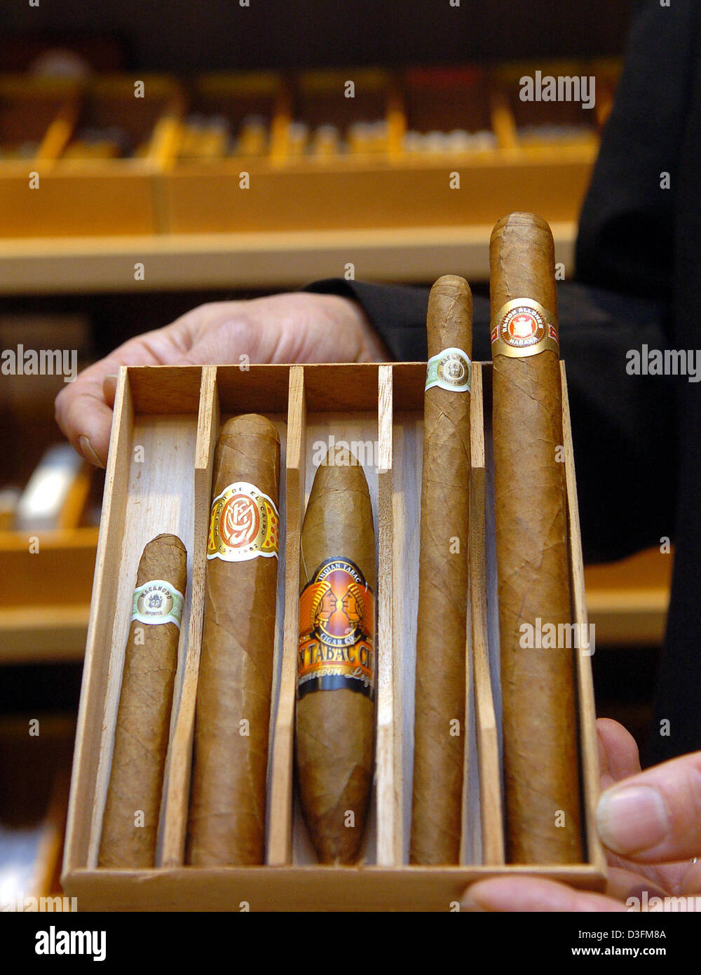 (dpa) - An employee of cigar store CWI Cigar World International holds ...
