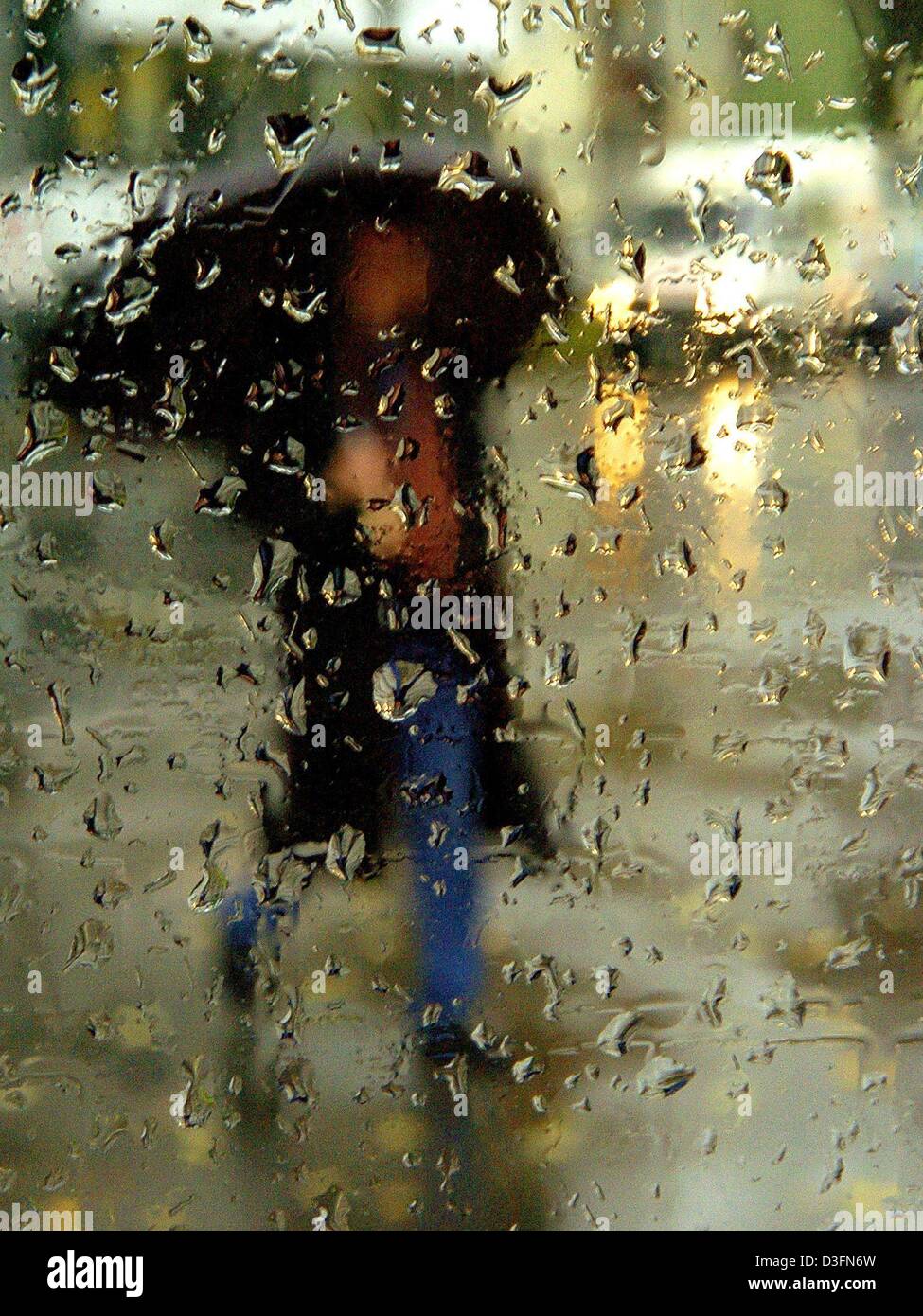 (dpa) - Through a glass window covered with raindrops can a man be seen ...