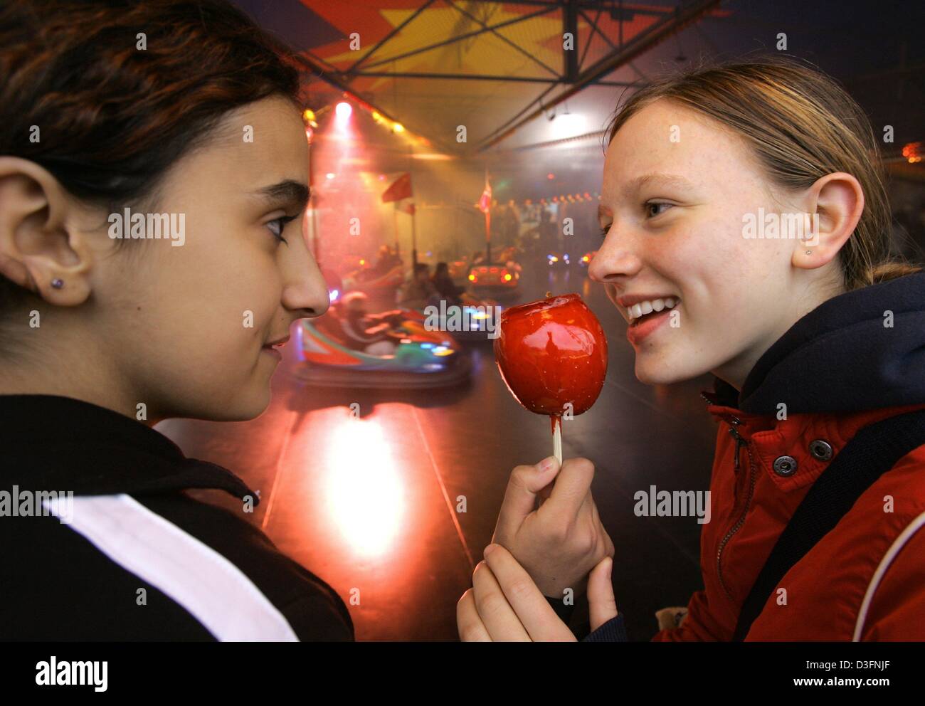 (dpa) - The pupils Maja (L) and Nicole enjoy a red candied apple at a ...