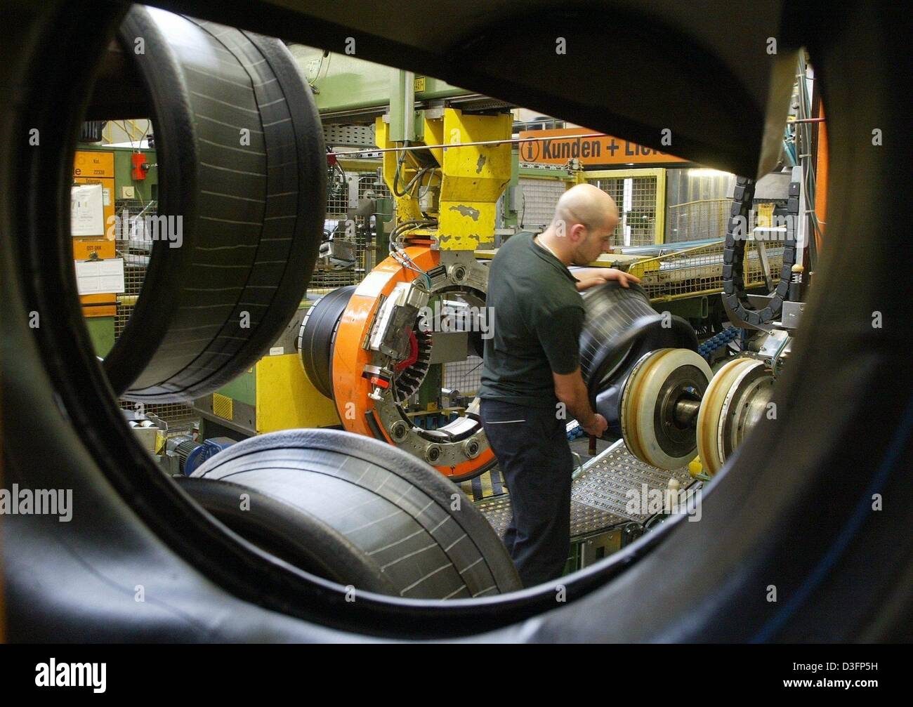 (dpa) - Ozean Demirezen equips a machine with tyre casings at the ...