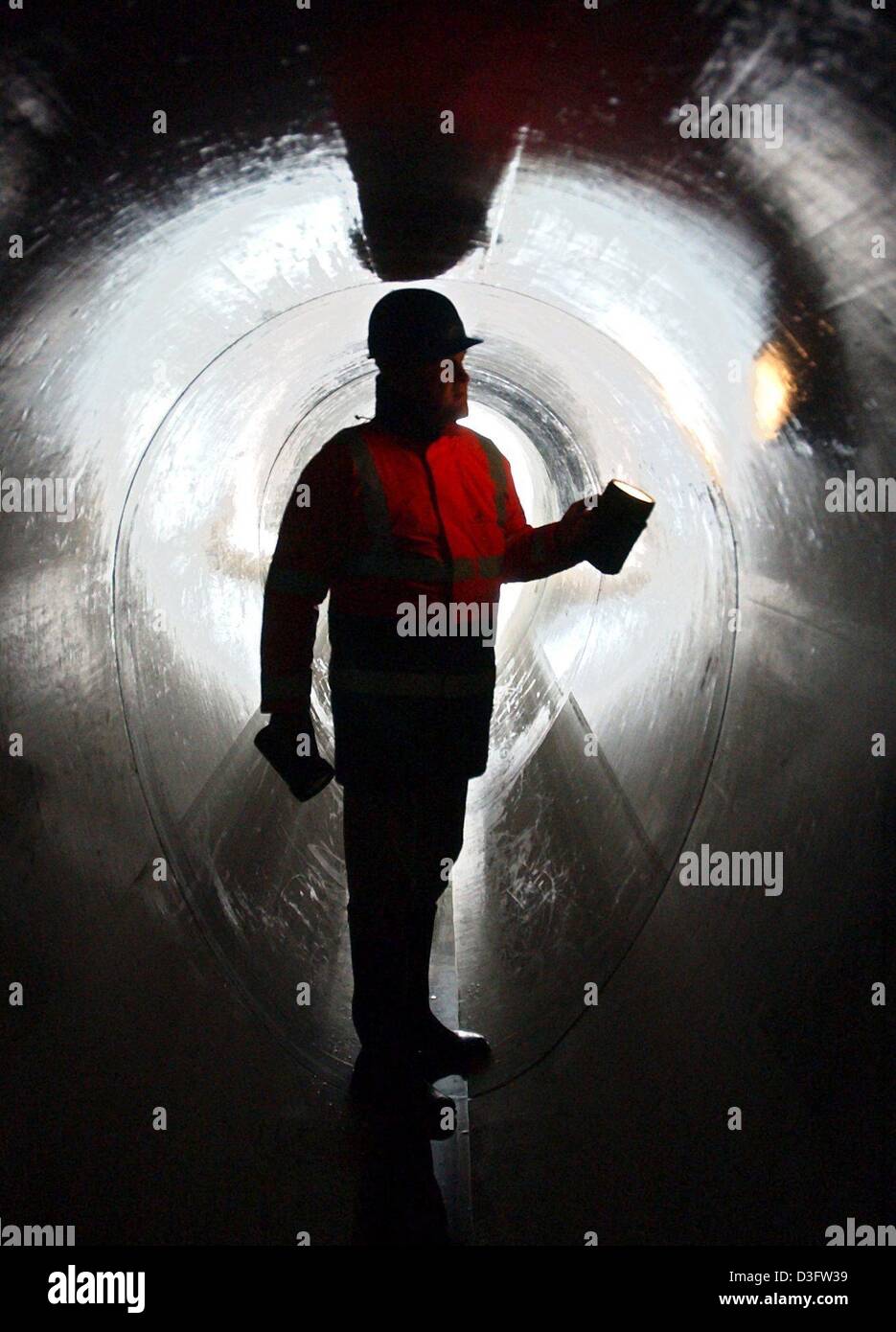 (dpa) - Engineer Uwe Wetzel examines the redeveloped part of a rain ...