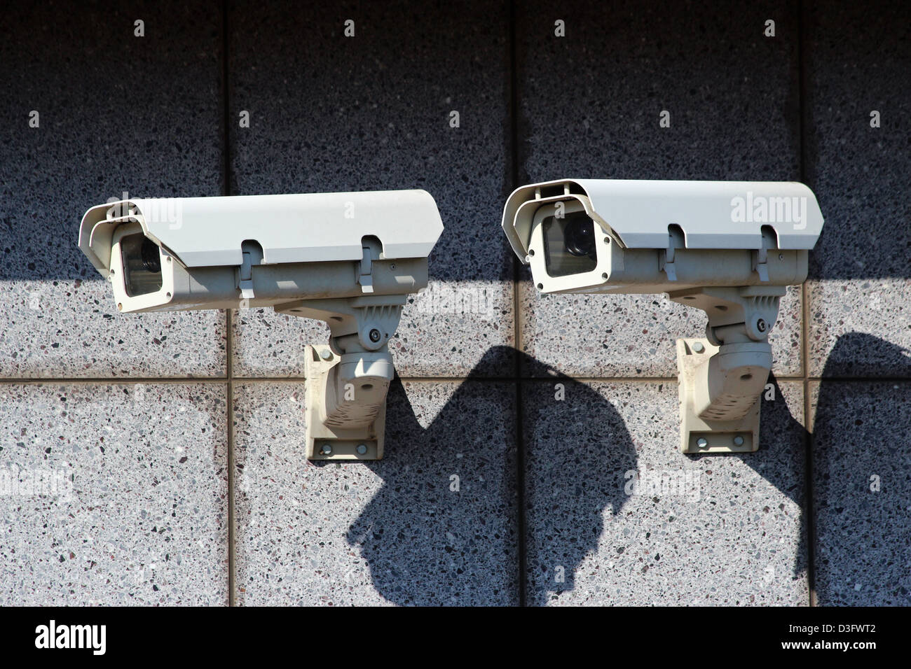 two white security cameras on the concrete wall Stock Photo - Alamy