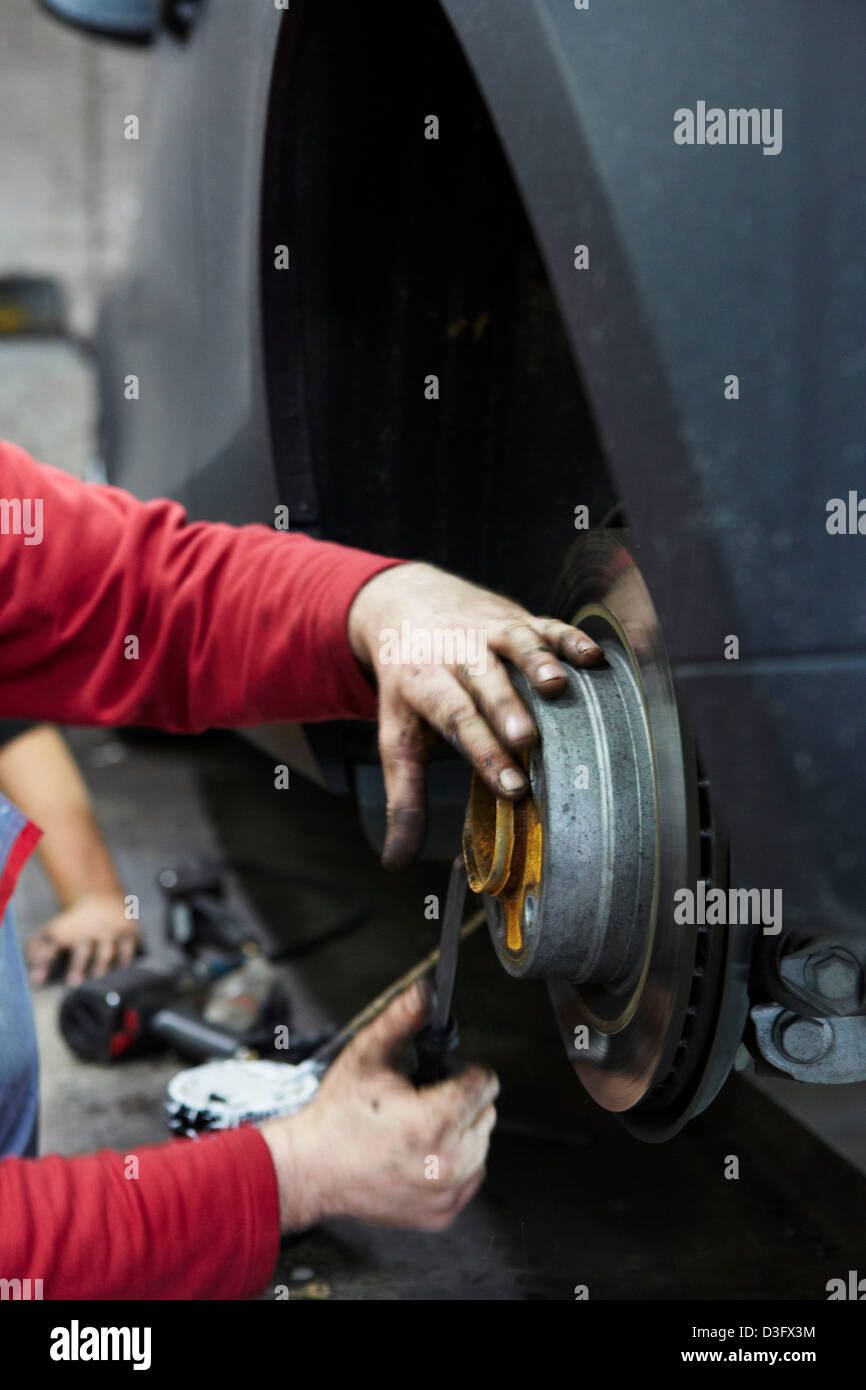 Car mechanic at work in his auto repair shop Stock Photo - Alamy