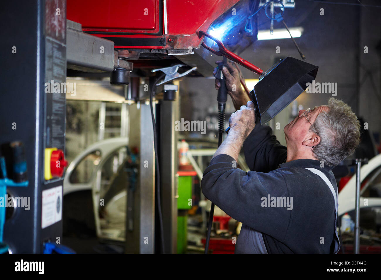 A car mechatronic during welding Stock Photo - Alamy