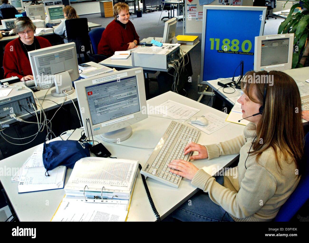 (dpa) - Employees of the information desk 'telegate' look up telephone ...