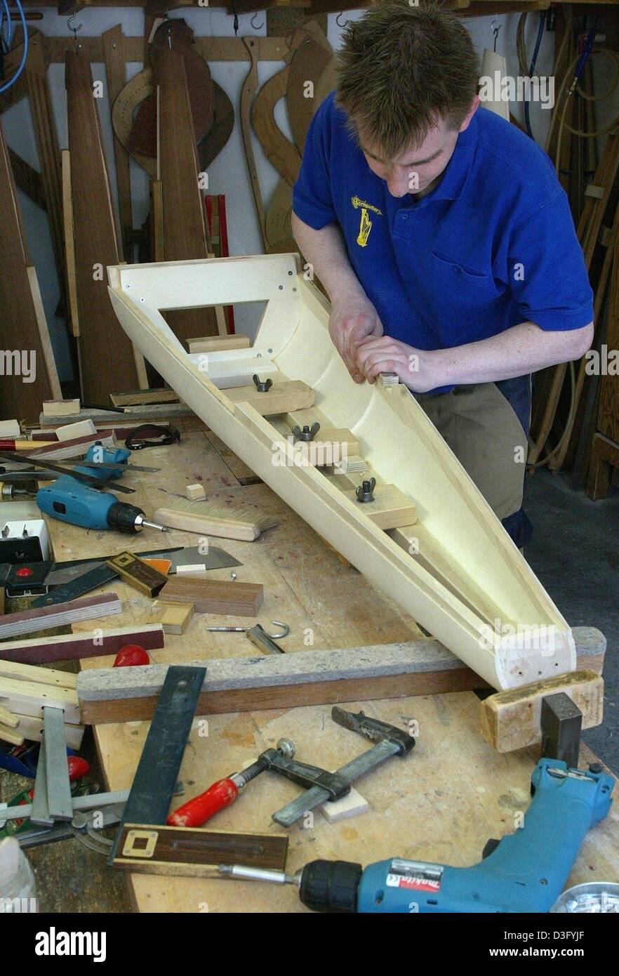 (dpa) - Mirko Kitz works on a raw body for a harp at the harp maker ...