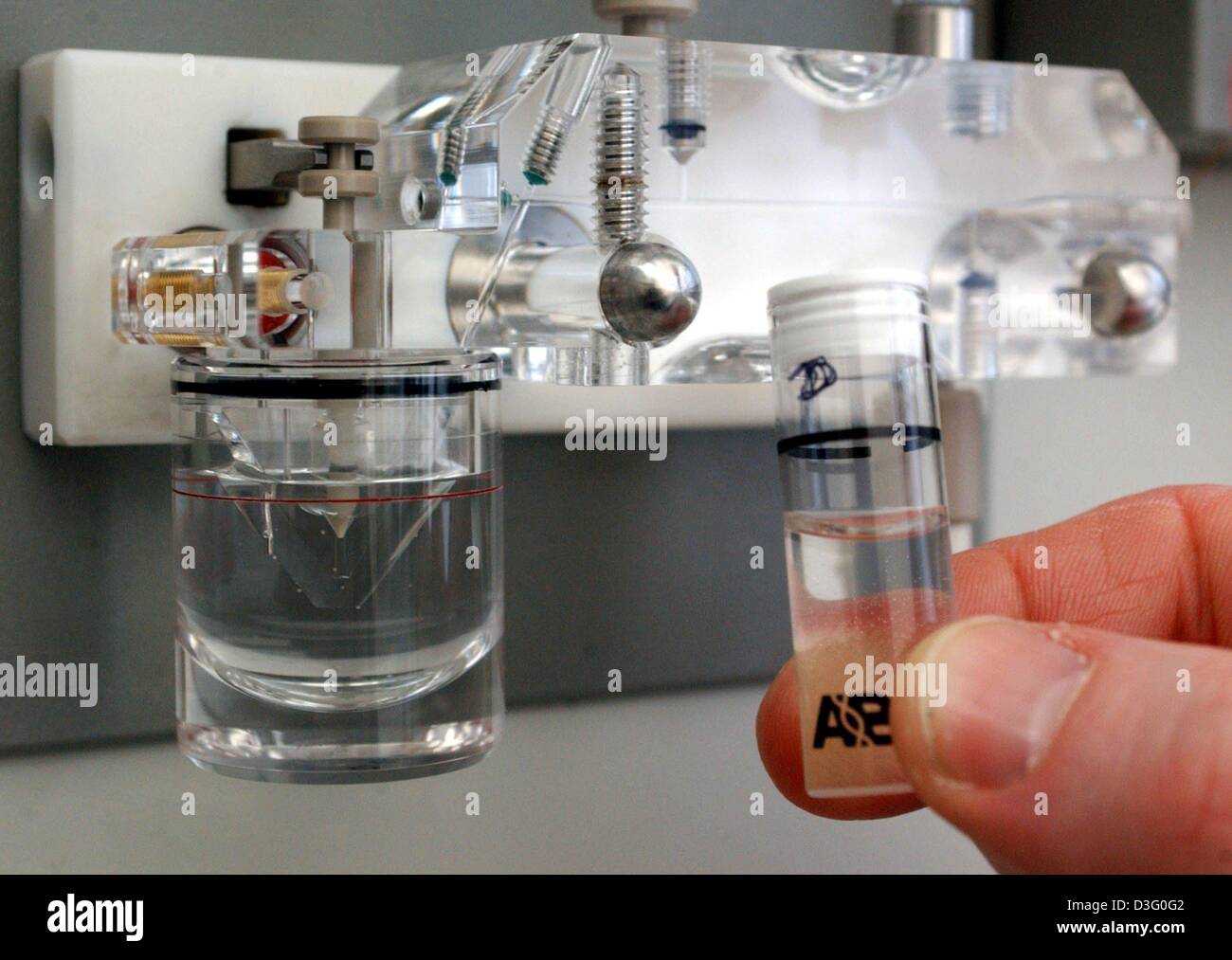 (dpa) - A blood sample is pictured in front of a DNA sequence analyser ...