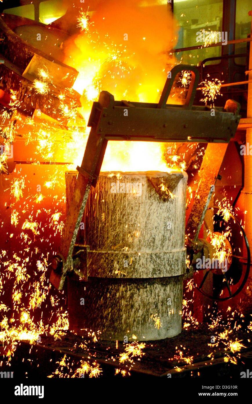 (dpa) - Sparks are spraying as melted steel is pouring from a slant ...