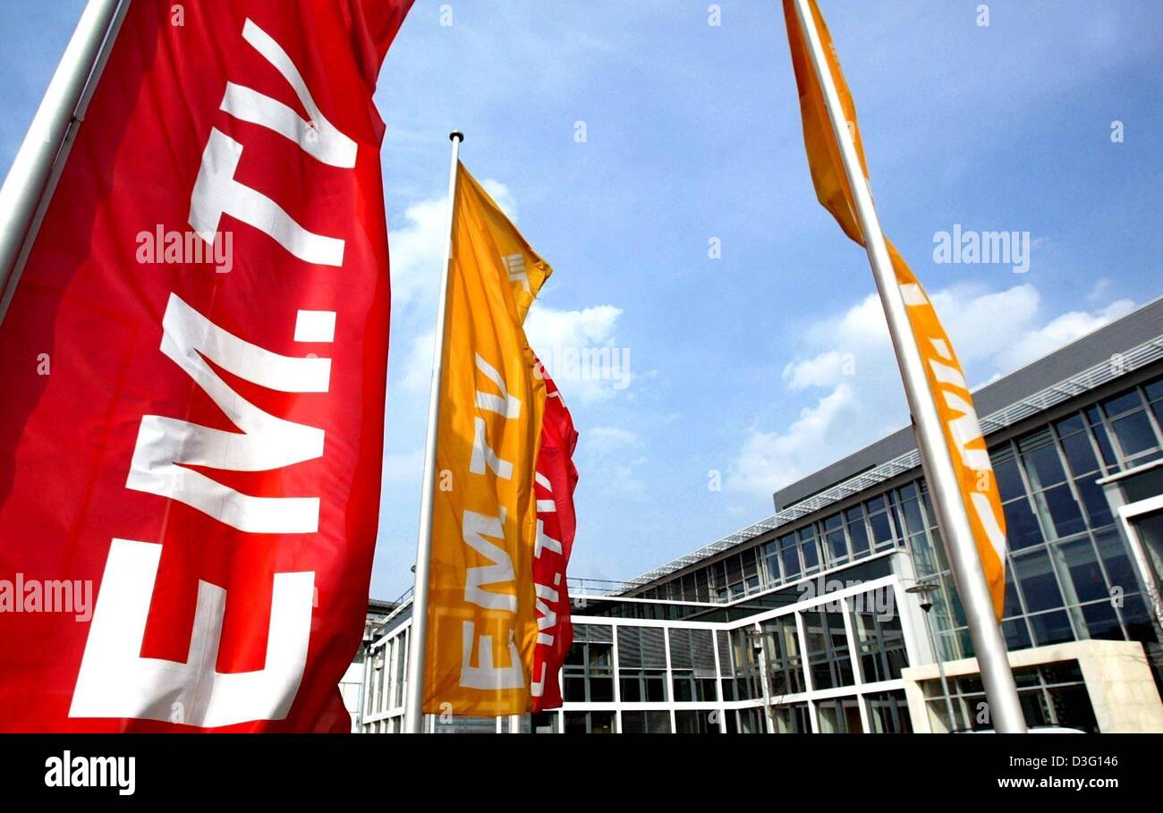 (dpa) - A view of flags flapping in the wind, with the company logo of ...