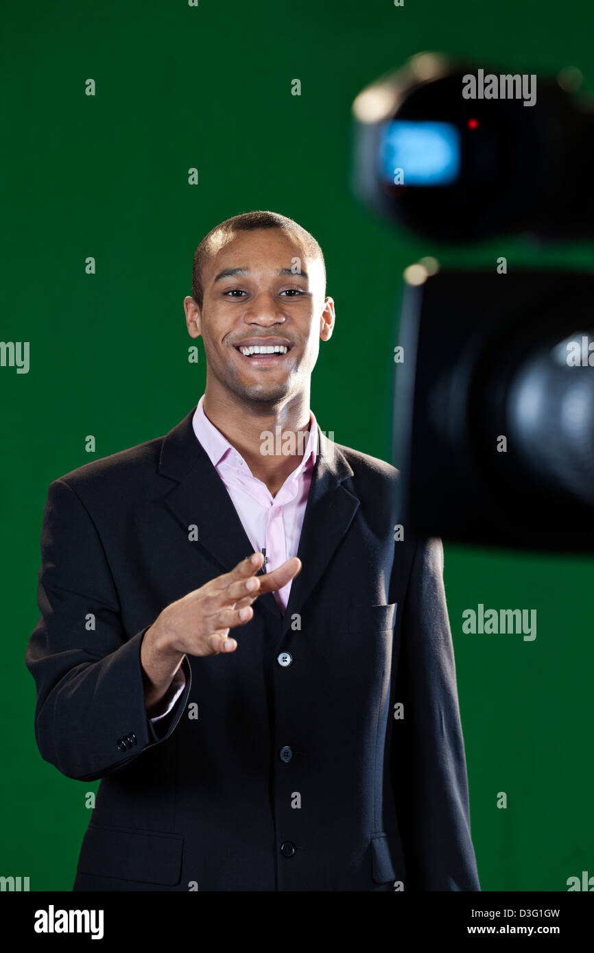 Television presenter in a green screen studio with television camera ...