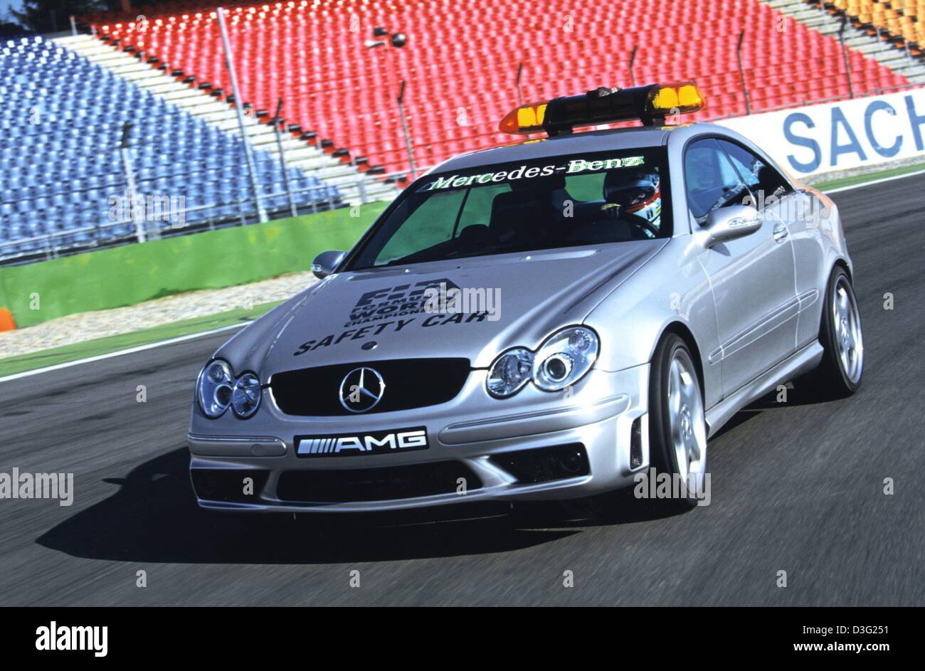 (dpa) - The Mercedes Benz CLK 55 AMG drives past a tribune on a track ...