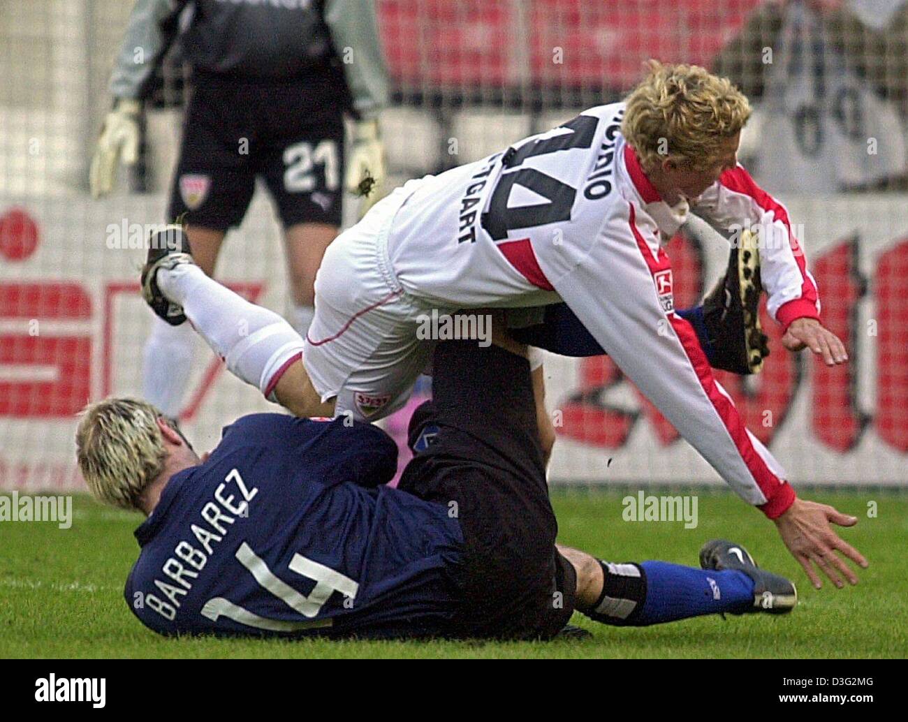 (dpa) - Stuttgart's midfielder Michael Rundio (top) falls over Hamburg ...