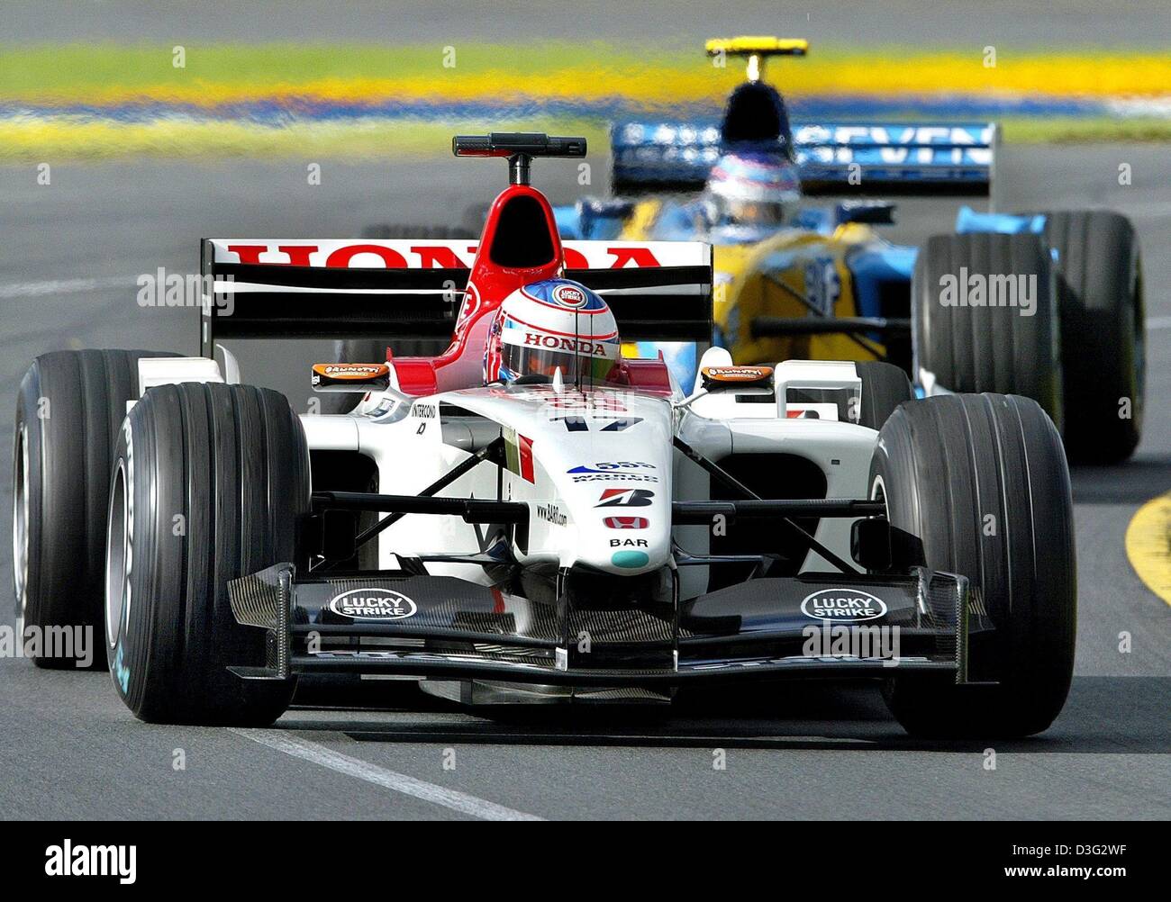 (dpa) - British formula one driver Jenson Button (front) drives in ...